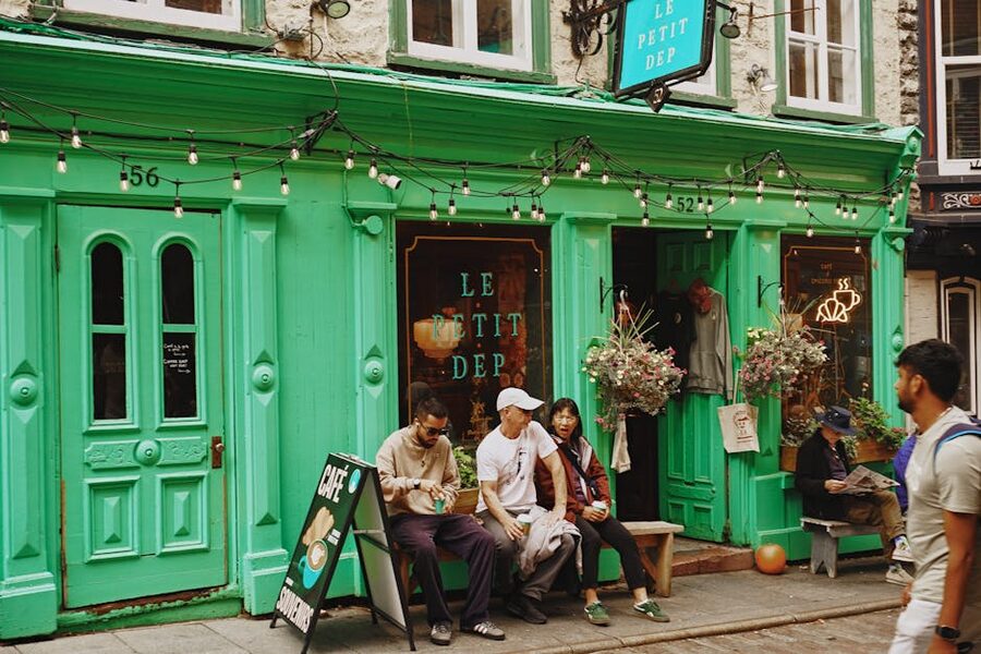 Colorful cafe facade in Old Quebec with people enjoying a sunny day