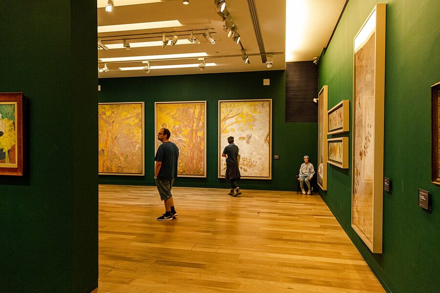 Musee d'Orsay interior with summer crowds in front of paintings