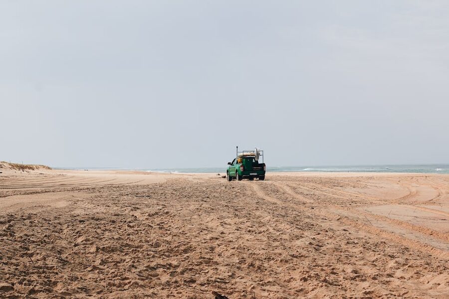 4x4 pickup truck driving on a sandy beach