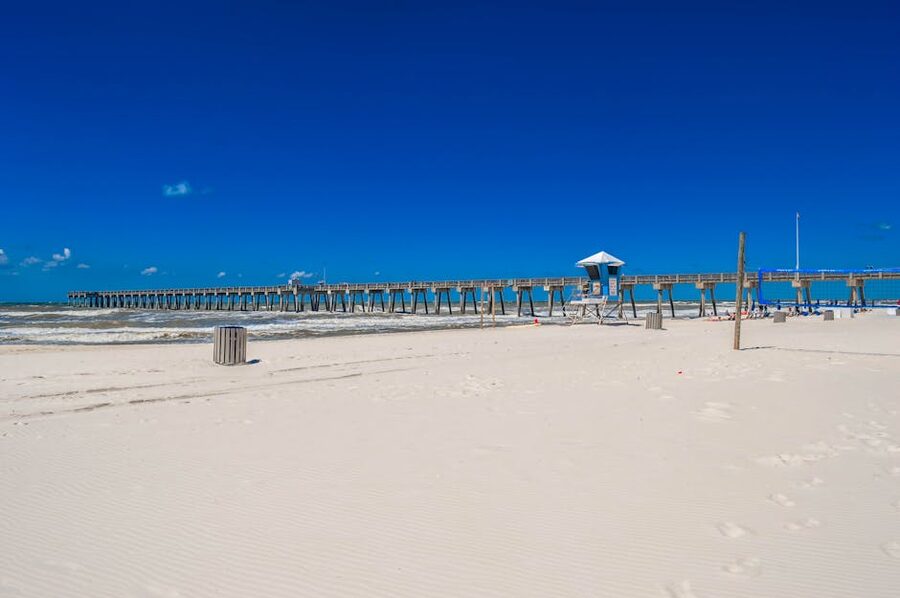 Pier and white sand at Panama City Beach