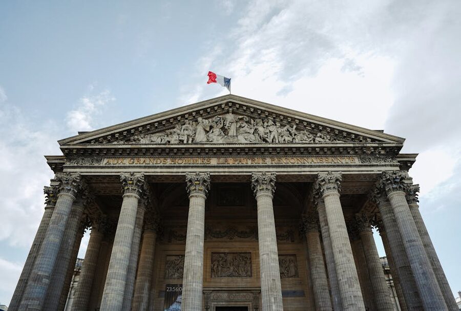 French flag flying above the Panthéon Paris classical columns
