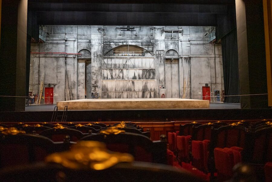 Empty Paris theatre stage with backdrop and seating