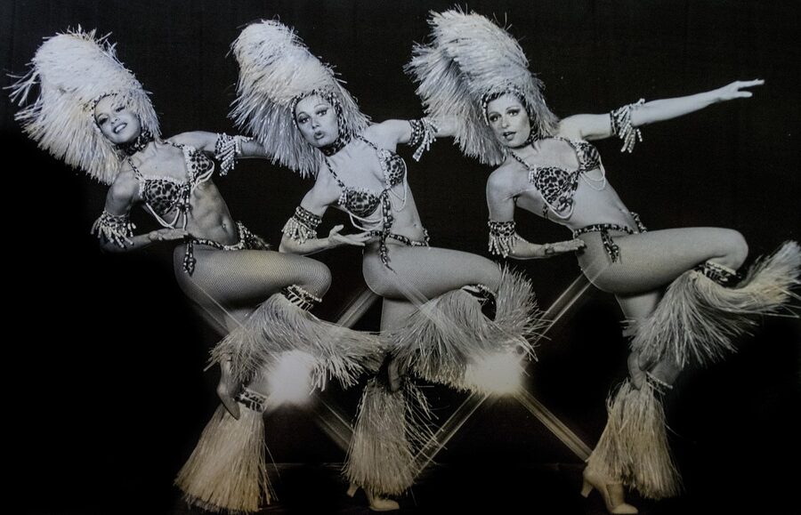 Cabaret showgirls in sequined costumes during a performance