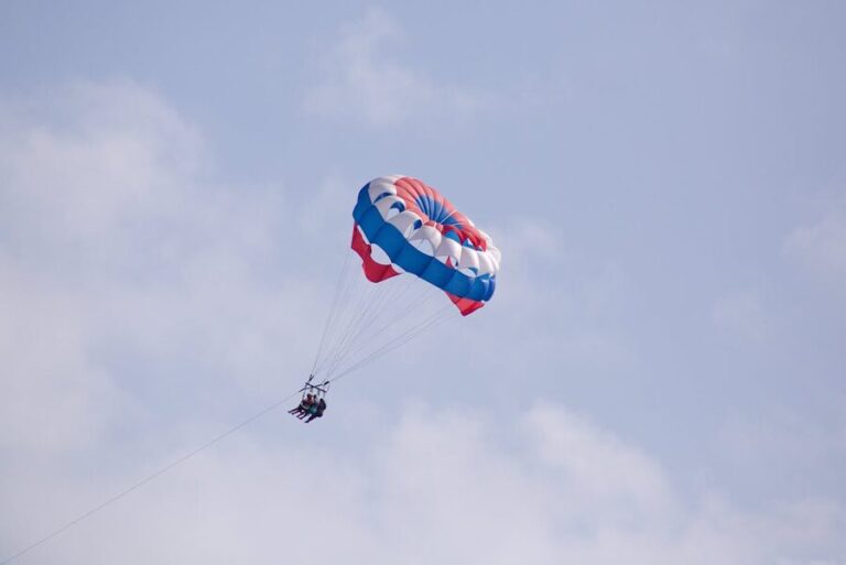 Parasailing experience over the ocean with clear blue sky