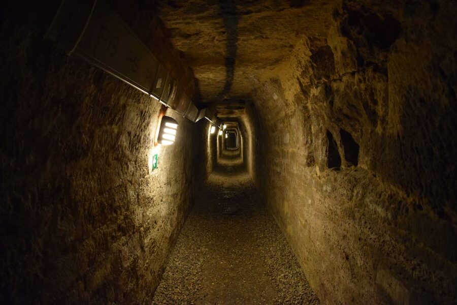 Mysterious dimly lit tunnel section deep inside the Paris Catacombs