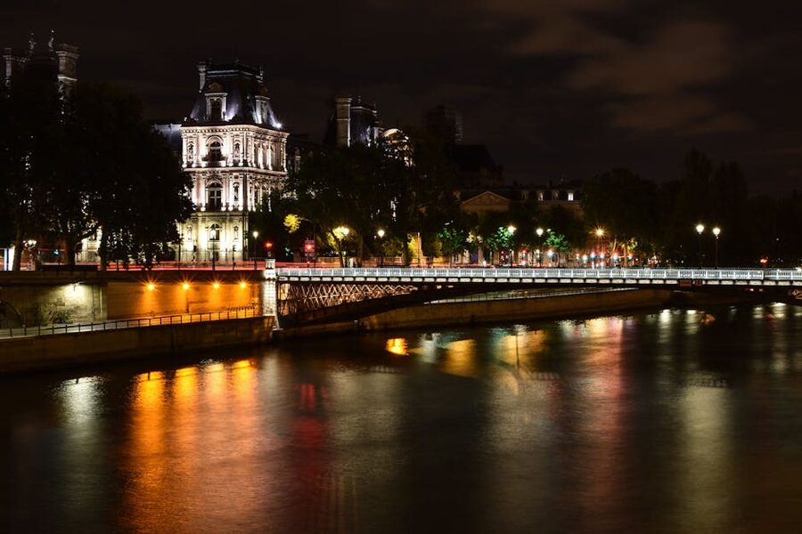 Eiffel Tower Paris at night reflected in the Seine