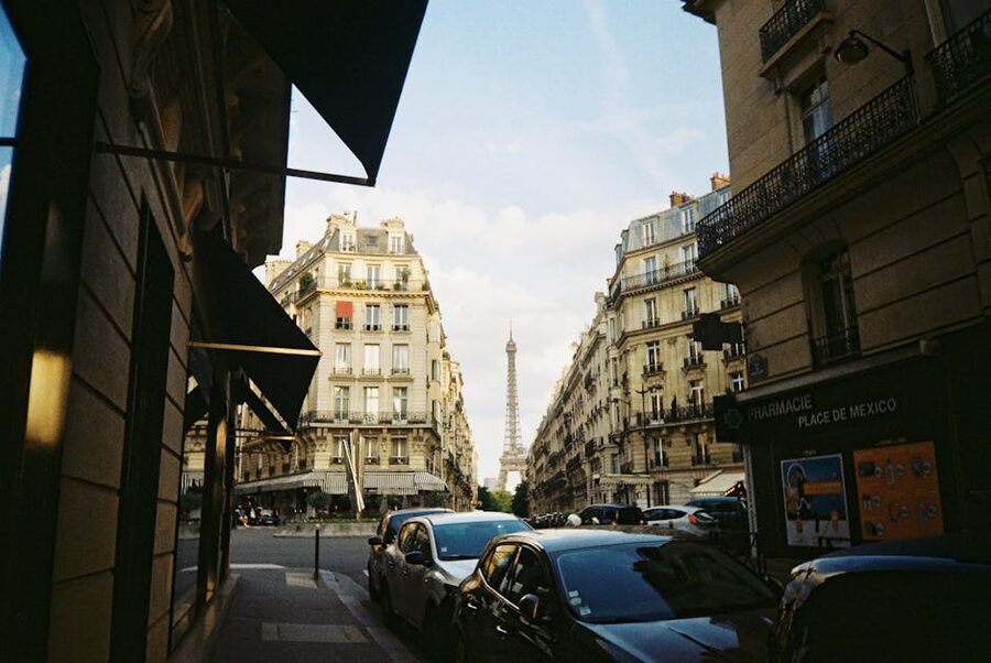 Eiffel Tower framed by Haussmann buildings with Paris street traffic