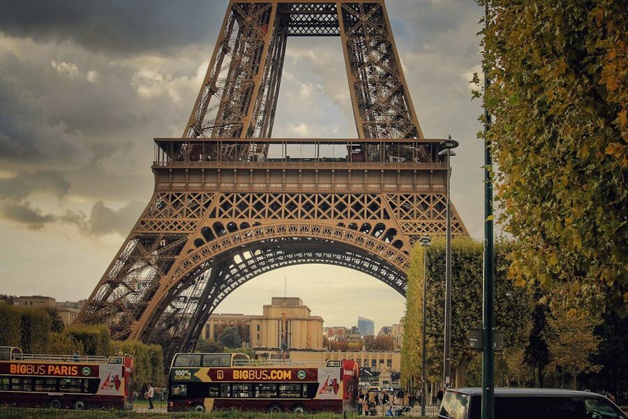 Eiffel Tower in Paris cityscape with hop on hop off sightseeing buses