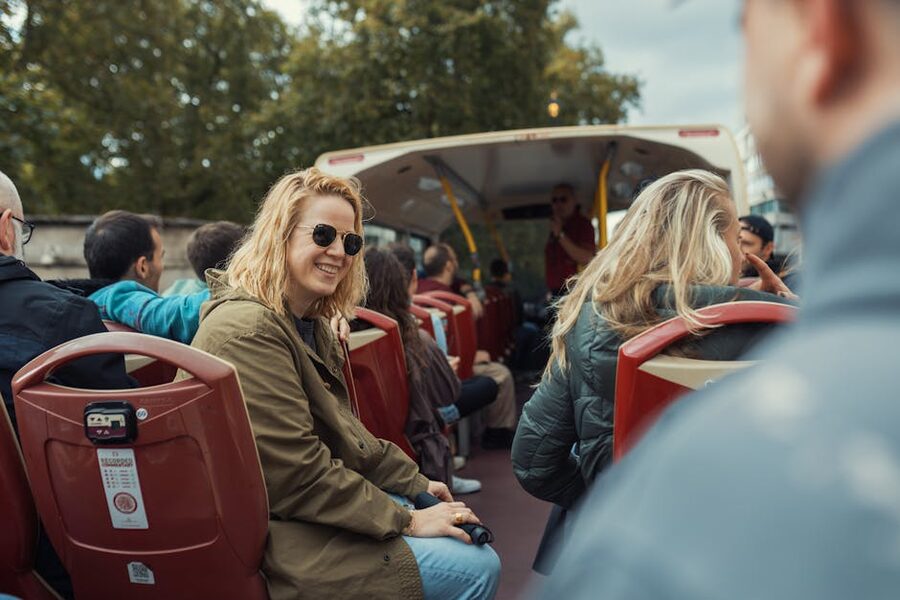 Passengers on the top deck of an open top sightseeing bus