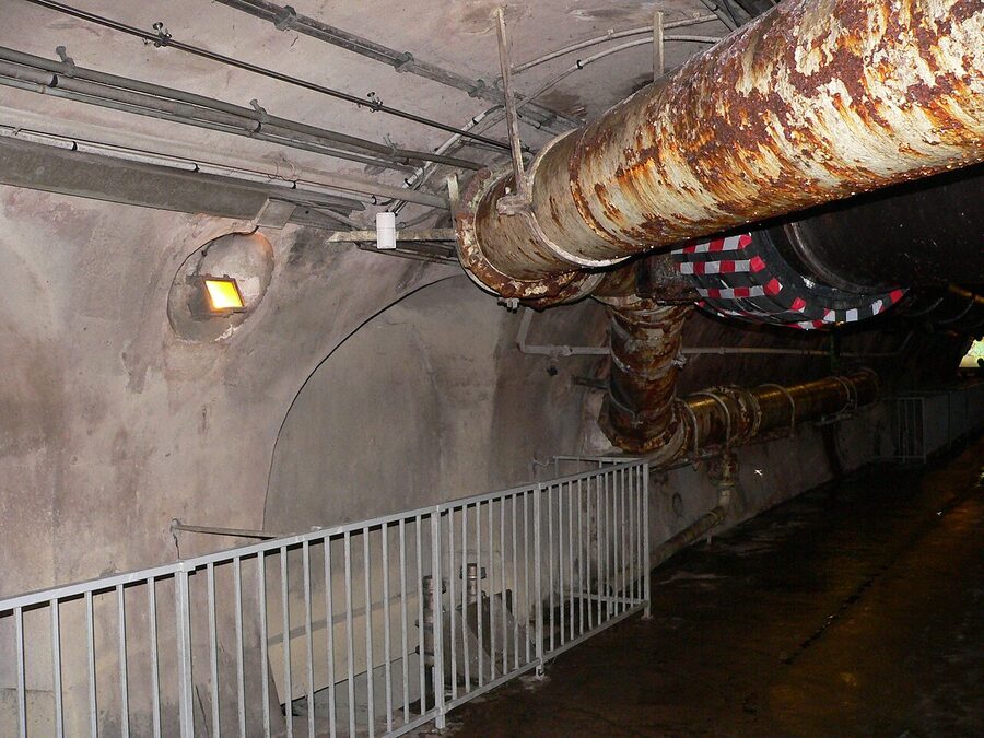 Underground street name sign in the Paris sewer matching the road above