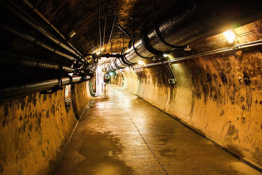 Visitor walkway above active flow inside Paris sewers
