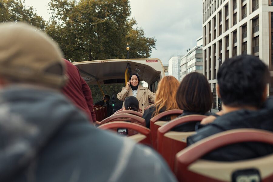 Group of people on an open top bus enjoying a city sightseeing tour