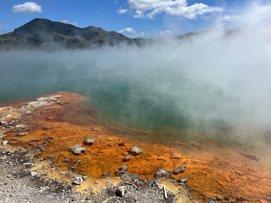 Steaming geothermal pool with mineral colours in Rotorua thermal area