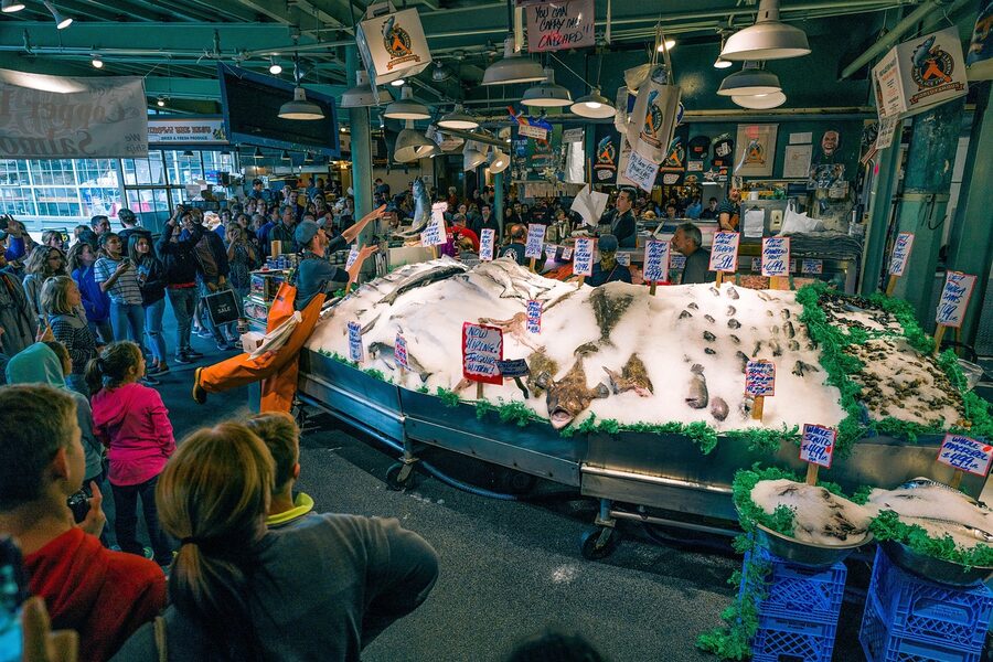 Pike Place fish throwing with salmon at the market counter