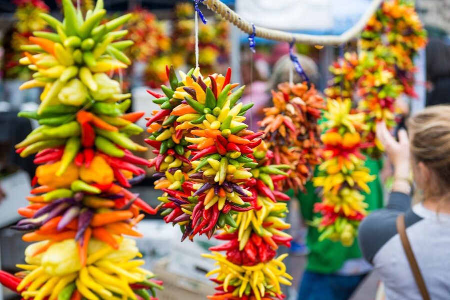 Hanging chili pepper bunches at Pike Place Market stall Seattle