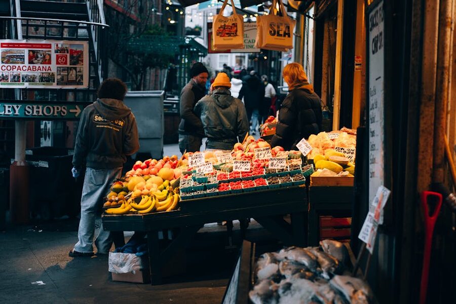 Busy Pike Place Market scene with produce stalls at dusk