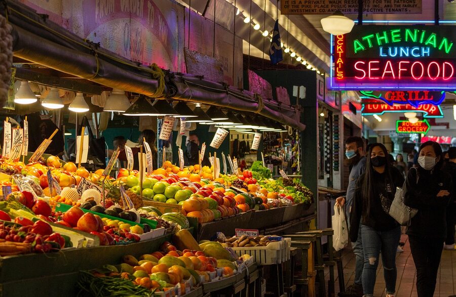 Pike Place Market produce stalls with vendor signs Seattle