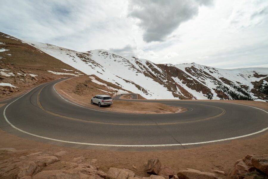 Pikes Peak Highway scenic mountain road with snow-covered peaks