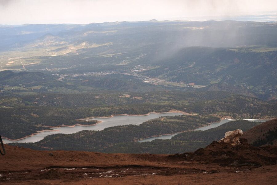 Scenic view from Pikes Peak summit looking at valley and reservoir below
