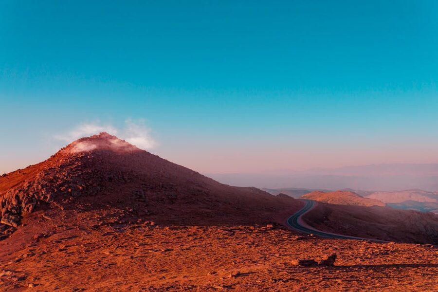 Pikes Peak sunrise view with winding mountain road Colorado