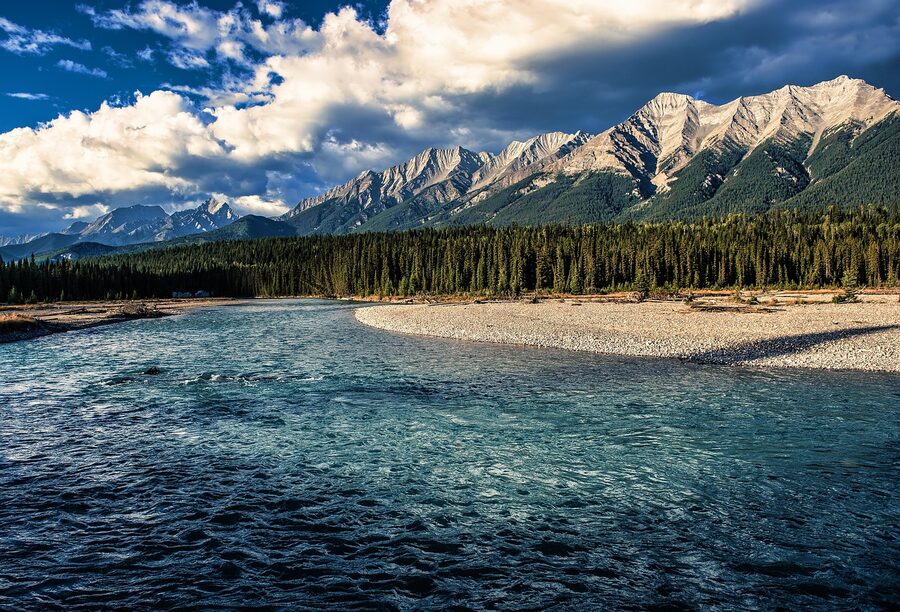 Bow River flowing past Banff mountains