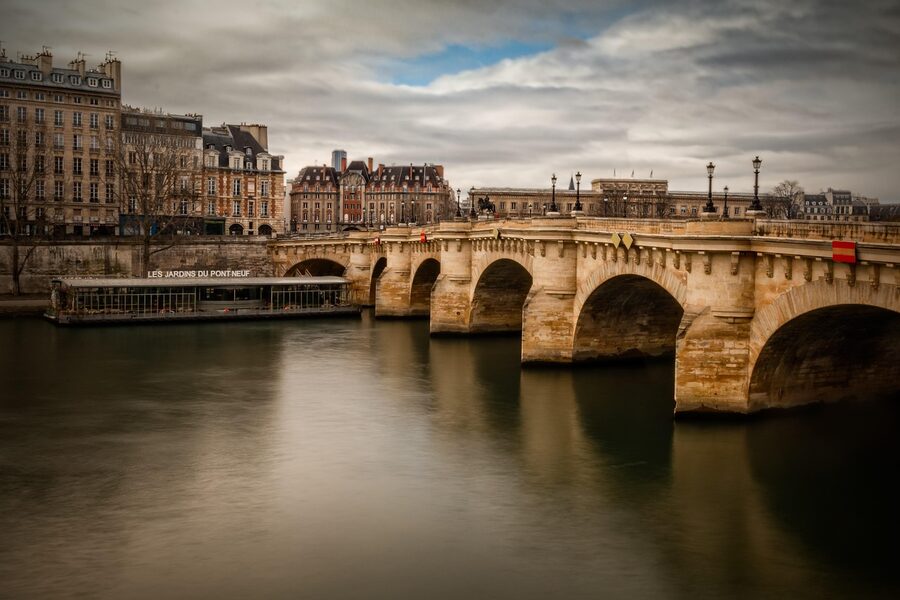 Pont Neuf bridge over the Seine Paris with boat passing