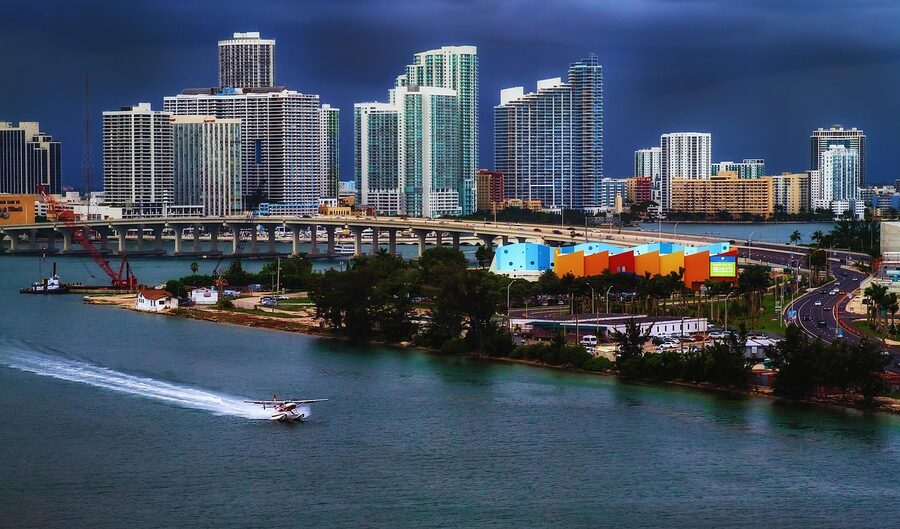 Aerial view of the Port of Miami shipping channel with downtown in the background