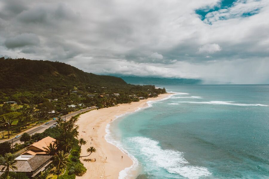 Aerial shot of Pupukea Beach turquoise waters and lush greenery in Hawaii
