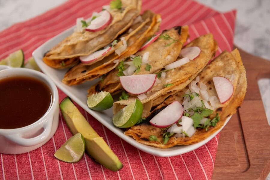 Mexican street tacos topped with radish, onion and cilantro