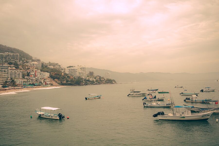 Sunset over Puerto Vallarta coastline with boats