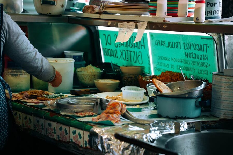 Street food vendor preparing Mexican dishes at a Puerto Vallarta stall