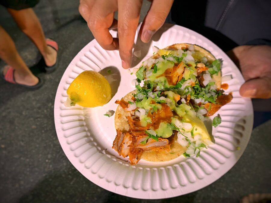 Close-up of tacos al pastor with pineapple and cilantro