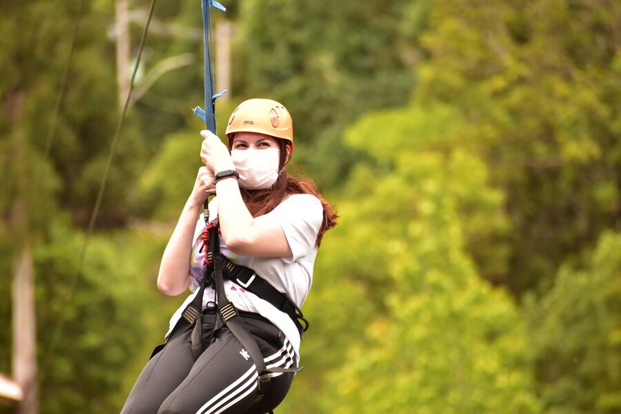 Woman on zipline wearing helmet and harness