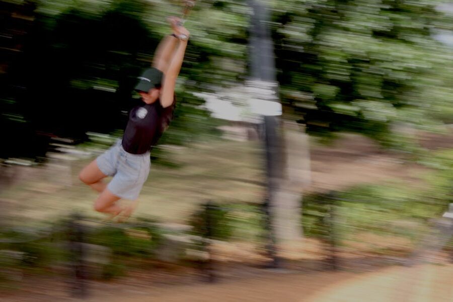 Person in motion blur on a fast zipline