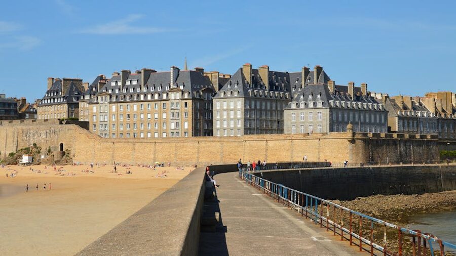 Saint-Malo beach beneath the city walls under blue sky