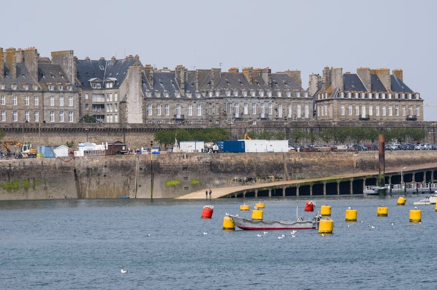 Saint-Malo harbor with historic stone facades and colorful boats
