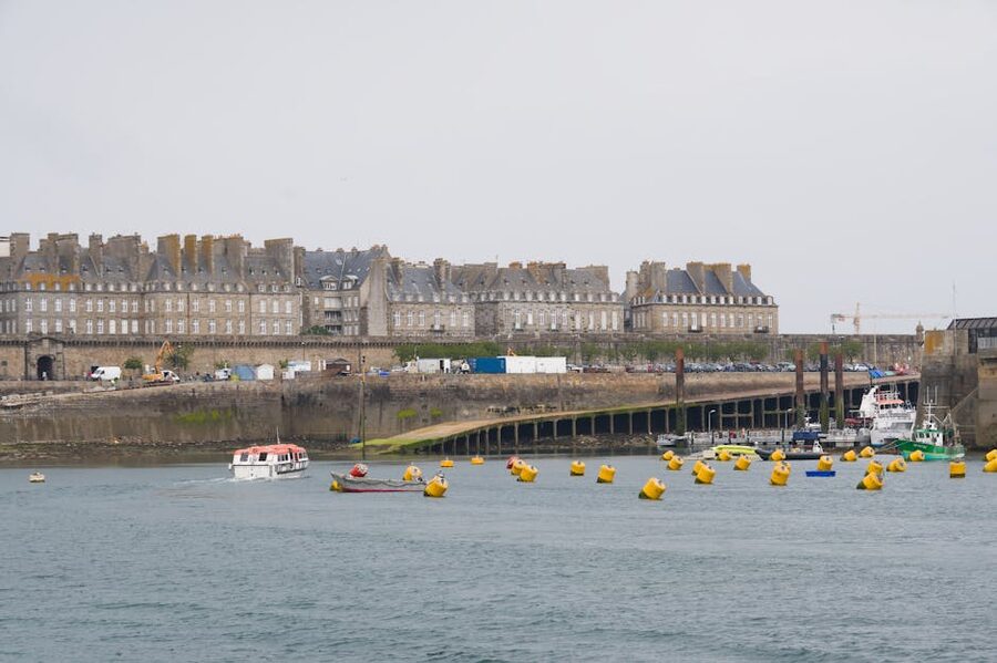 Saint-Malo port with boats and historic walled city behind