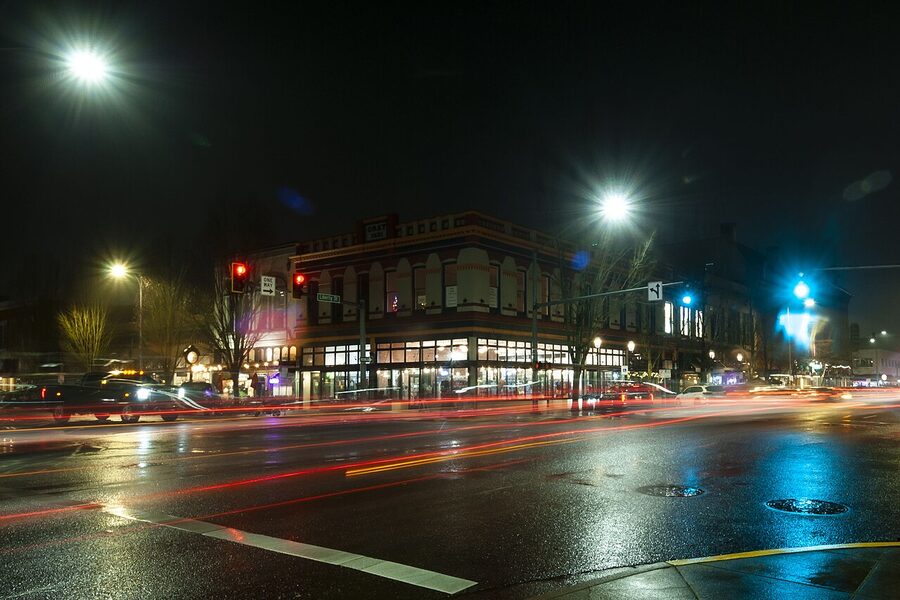Downtown Salem Massachusetts at night with wet streets and glowing shop lights