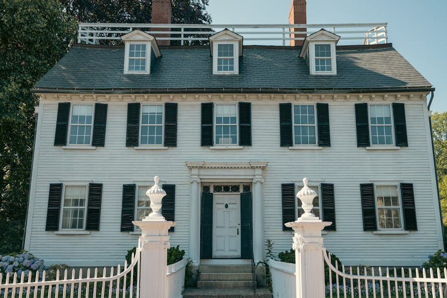 Colonial home in Salem Massachusetts with black shutters and white picket fence