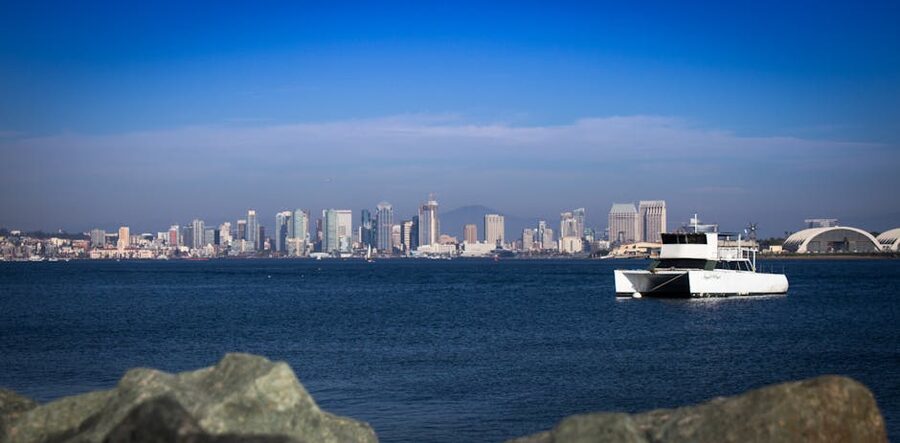 San Diego skyline from the water with a white yacht in the foreground