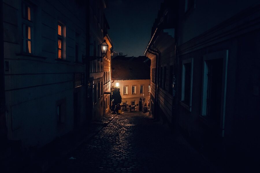Cobblestone alley at night old town atmospheric ghost walking tour