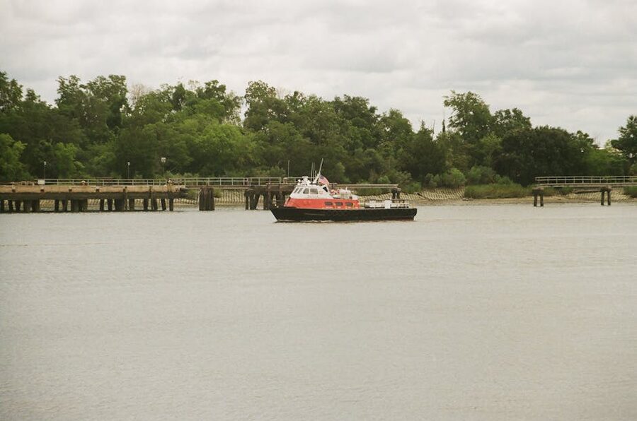 Tugboat on the Savannah River with lush greenery on the bank