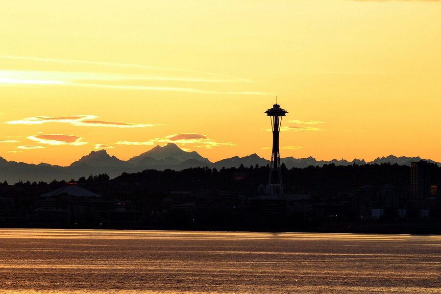 Sunrise silhouette of Seattle skyline and Space Needle from Elliott Bay