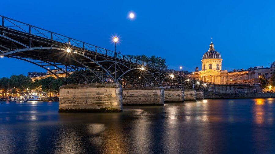 Pont des Arts at night with Seine reflections in Paris