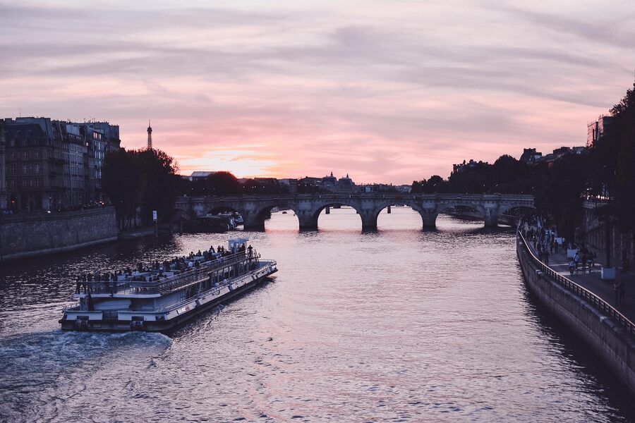 Sunset Seine cruise boat with Paris cityscape