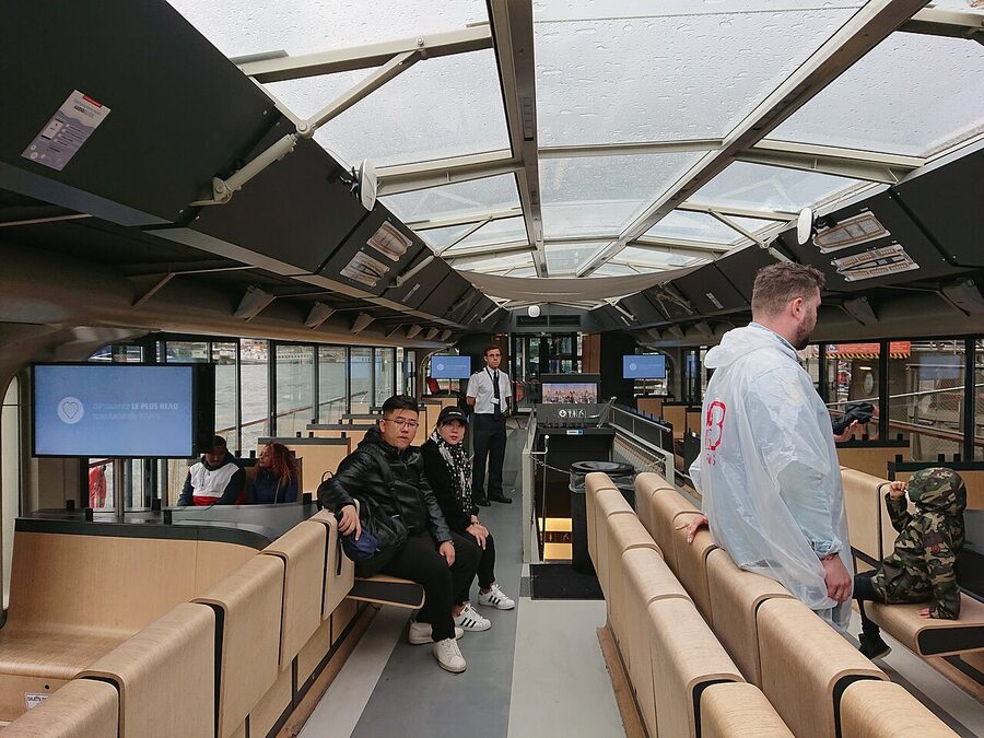Tourists on the deck of a Bateaux Mouches Seine cruise