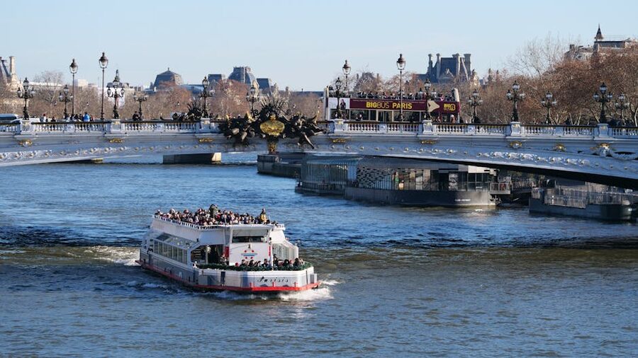 Seine cruise boat passing under Pont Alexandre III in Paris