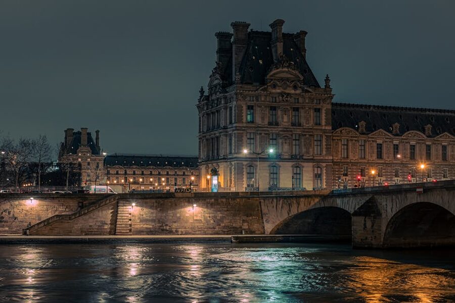 Louvre Museum lit up beside the Seine at night
