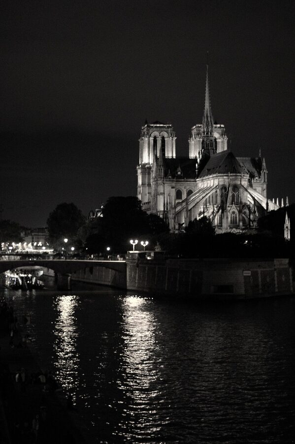 Notre-Dame Cathedral at night across the Seine in Paris