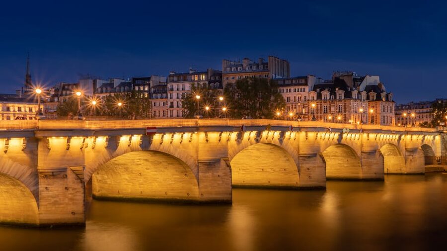 Pont Neuf bridge lit up over the Seine at night